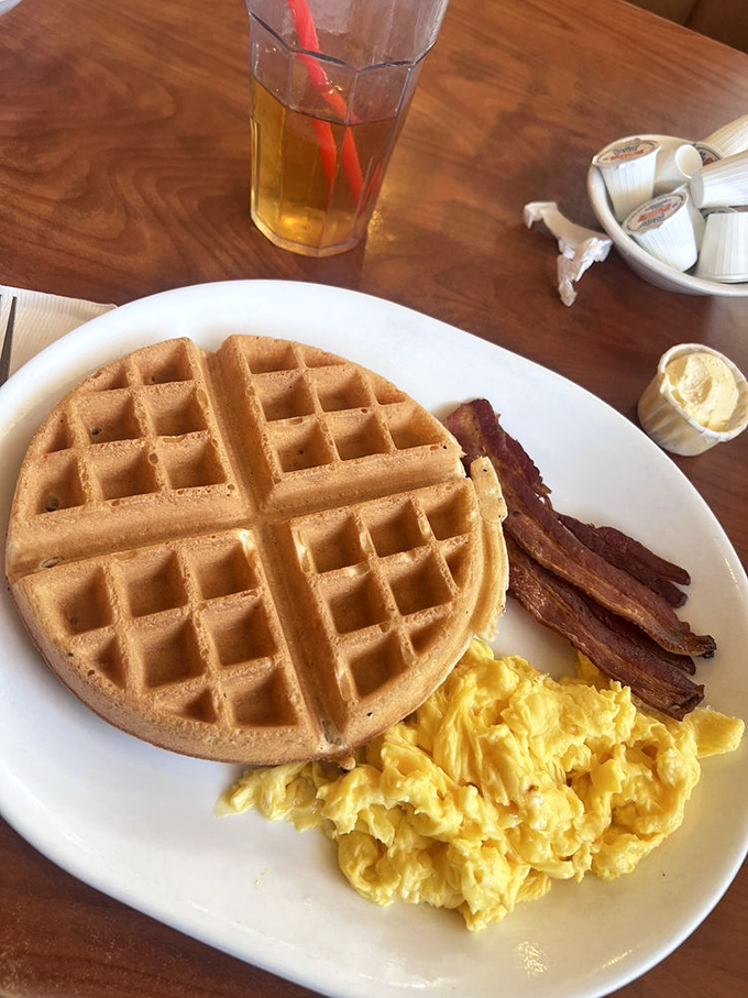 Waffles that could double as edible quilts, paired with eggs and bacon in perfect breakfast harmony.