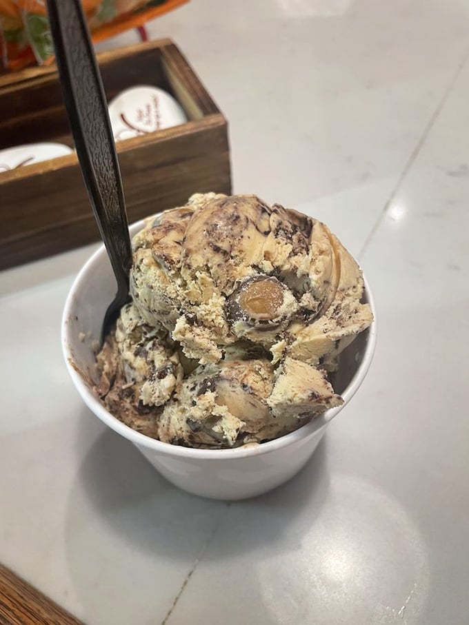 Behold the holy grail of Ohio desserts: peanut butter ice cream studded with chocolate-covered buckeyes. It's state pride you can eat with a spoon. 
