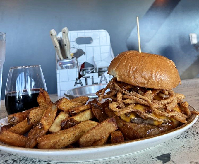 This isn't just a burger&mdash;it's architecture with cheese. Those crispy onion strings aren't garnish; they're the crown jewels of this royal feast.