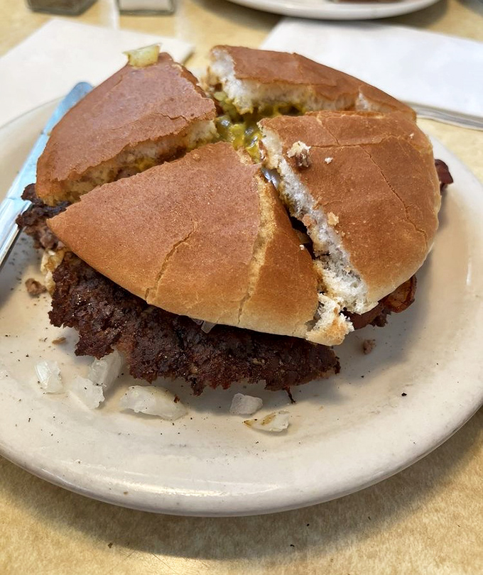 Behold the star of the show: a perfectly smashed patty with crispy edges that would make any fancy steakhouse burger weep with inadequacy.