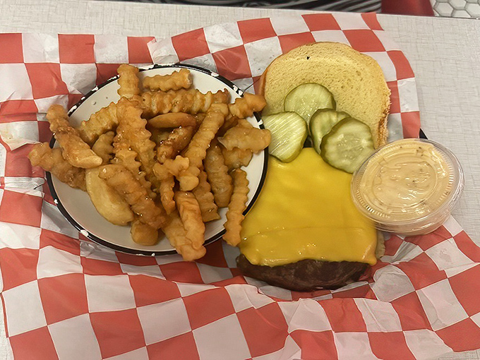 That's not just a burger—it's edible nostalgia with a side of perfectly crinkled fries. The pickle chips stand guard like delicious sentinels.
