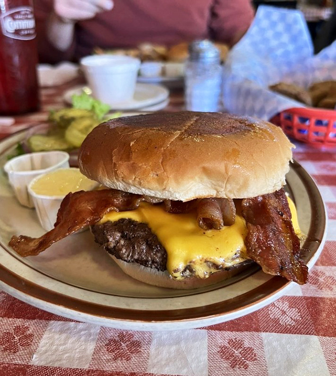 This isn't just a burger; it's an edible monument to simplicity. Melted cheese cascading over a hand-formed patty with bacon performing its salty symphony.