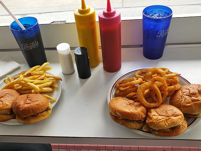 A feast fit for royalty on a commoner's budget: golden sliders, crispy onion rings, and perfectly salted fries—the holy trinity of diner delights.