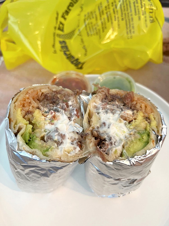 Behold the cross-section of burrito perfection &ndash; where avocado, meat, rice, and beans coexist in foil-wrapped harmony that would make the UN jealous.