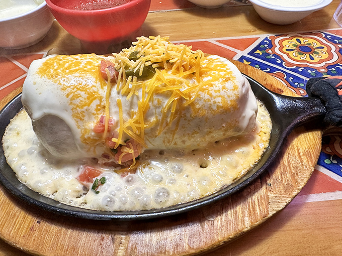This isn't just a burrito – it's a cheese-blanketed flavor bomb that requires both hands, several napkins, and absolutely zero shame.