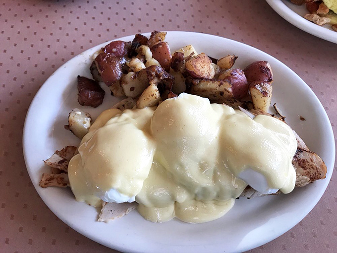 Hollandaise sauce cascading over perfectly poached eggs and crispy potatoes &ndash; a California Benedict that makes you question all other breakfast decisions.