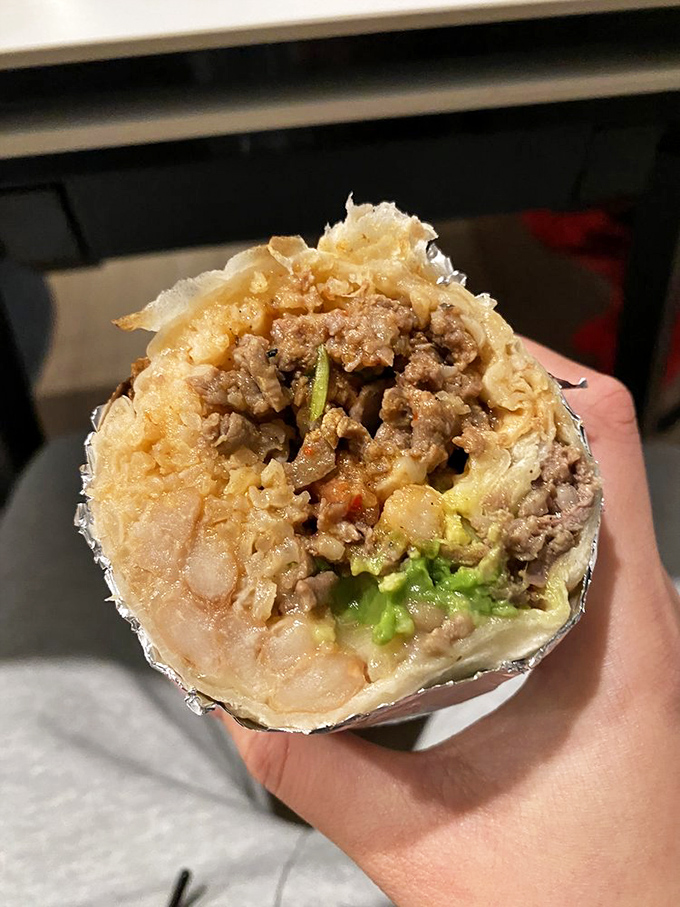 Cross-section perfection! Like a geological marvel, each layer of this carne asada super burrito tells a delicious story of texture and flavor.