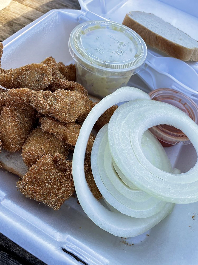 Golden-brown nuggets of catfish heaven, served with sliced onions and homemade tartar sauce. These fritters don't need fancy plating&mdash;they let their flavor do all the talking.