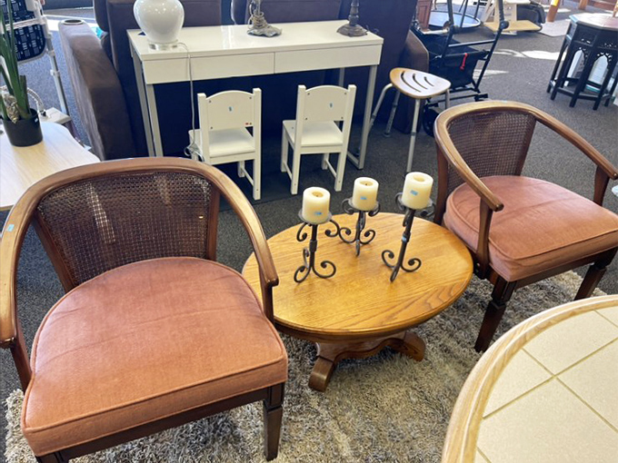A living room vignette that whispers, "Yes, you can afford to be this sophisticated," with cane-back chairs that would make any interior designer nod approvingly.
