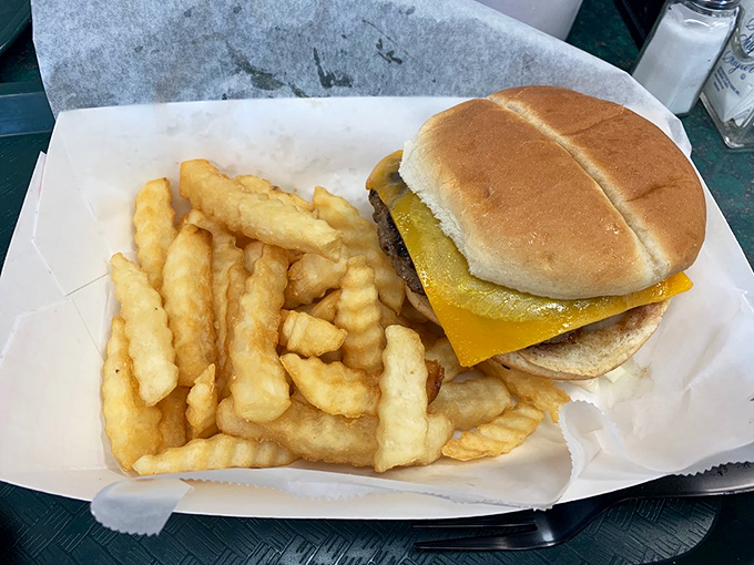The classic cheeseburger and crinkle-cut fries&mdash;a duo more iconic than Batman and Robin. Simple perfection served on paper, as the food gods intended.