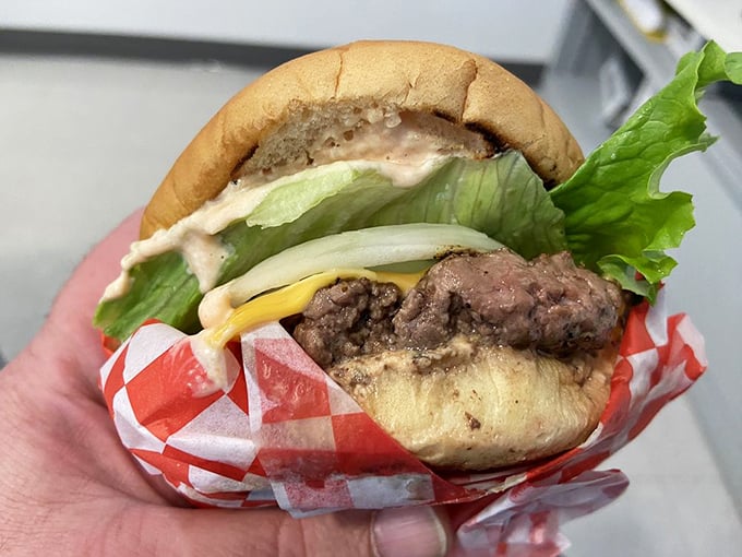 The classic cheeseburger in its natural habitat&mdash;wrapped in checkered paper and stuffed with fresh ingredients. Simplicity that sings.
