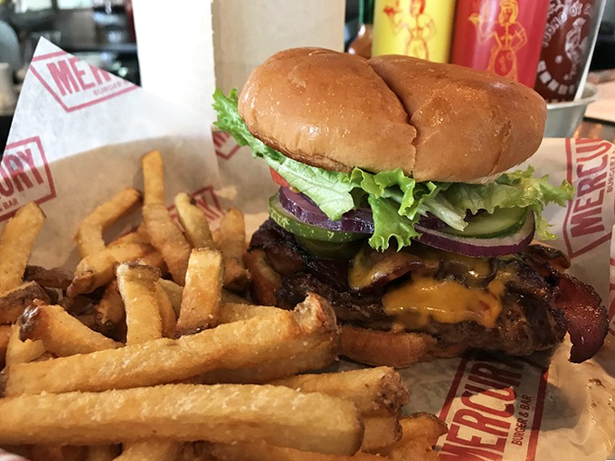 Behold the burger in its natural habitat&mdash;juicy, perfectly stacked, and flanked by golden hand-cut fries. Napkins required, not optional.