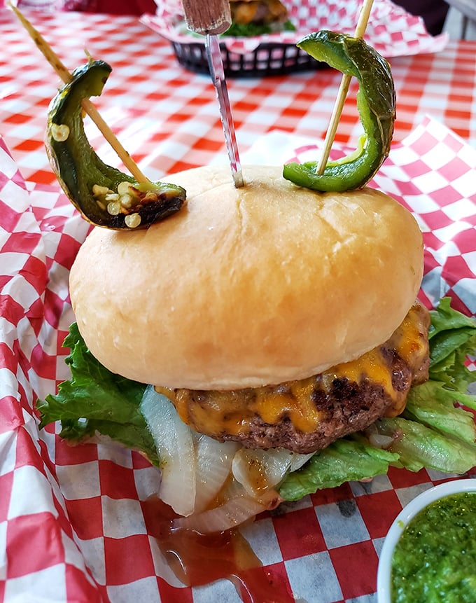 Not all heroes wear capes&mdash;some wear pickle horns and melted cheese. This burger's architectural integrity deserves an engineering award.