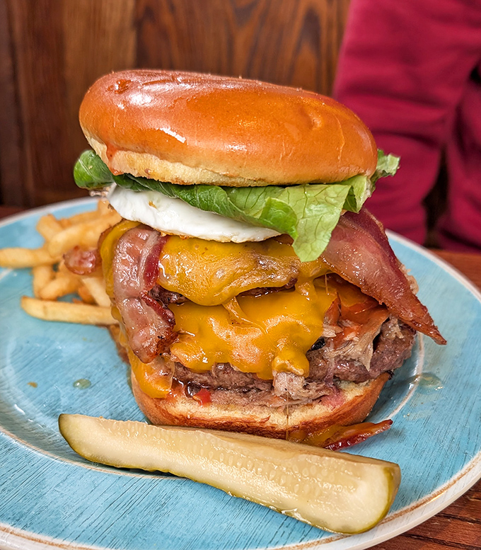 Behold, burger perfection! Melted cheese cascading over a juicy patty with bacon standing at attention&mdash;this is edible architecture at its finest.