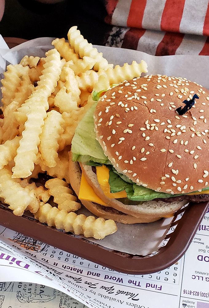 This isn't just a burger&mdash;it's edible architecture with a foundation of sesame-studded bun supporting layers of crisp lettuce, melted cheese, and beef that actually tastes like beef.
