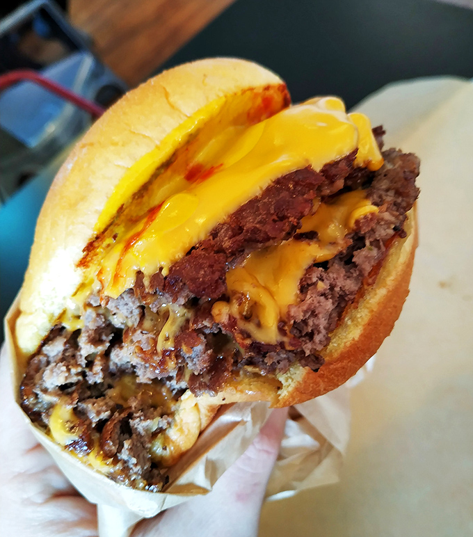 The money shot! Perfectly melted cheese cascading down hand-formed patties. This isn't a burger&mdash;it's edible artwork.