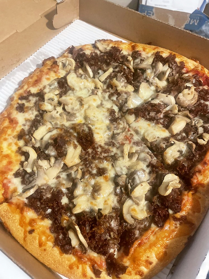 Behold the legendary pizza cheesesteak in its natural habitat&mdash;where finely chopped steak and mushrooms mingle under a blanket of perfectly melted cheese.