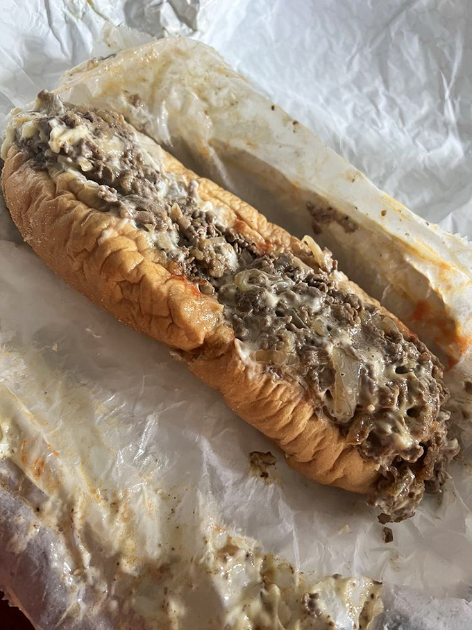 Behold the star of the show—thinly sliced ribeye embraced by melted cheese in perfect harmony. This isn't a sandwich; it's a religious experience.