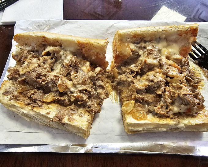 Behold the star attraction: a perfectly constructed cheesesteak where melted cheese mingles with tender meat in a dance as old as Philadelphia itself.