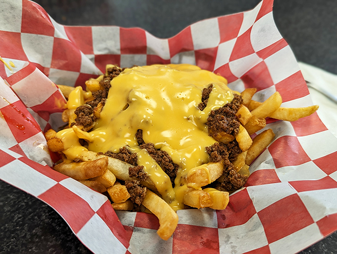 Cheese fries that don't apologize for their indulgence—golden fries under a lava flow of cheese and seasoned beef that says "diet starts tomorrow."
