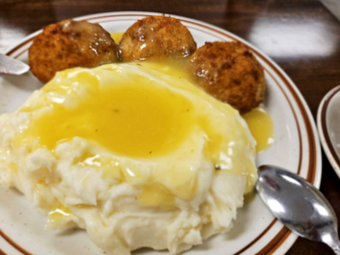 Golden-brown chicken croquettes bathed in silky gravy atop cloud-like mashed potatoes&mdash;proof that heaven exists and it's made of comfort food.