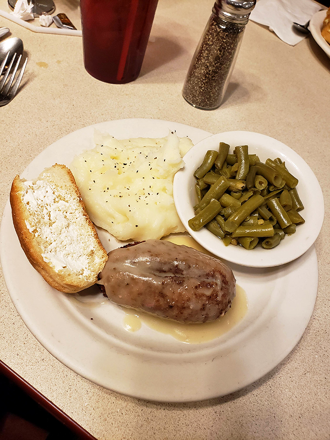 Salisbury steak done right is a dying art form. This plate delivers nostalgia with gravy that doesn't come from a packet and mashed potatoes that have actually met a real potato.