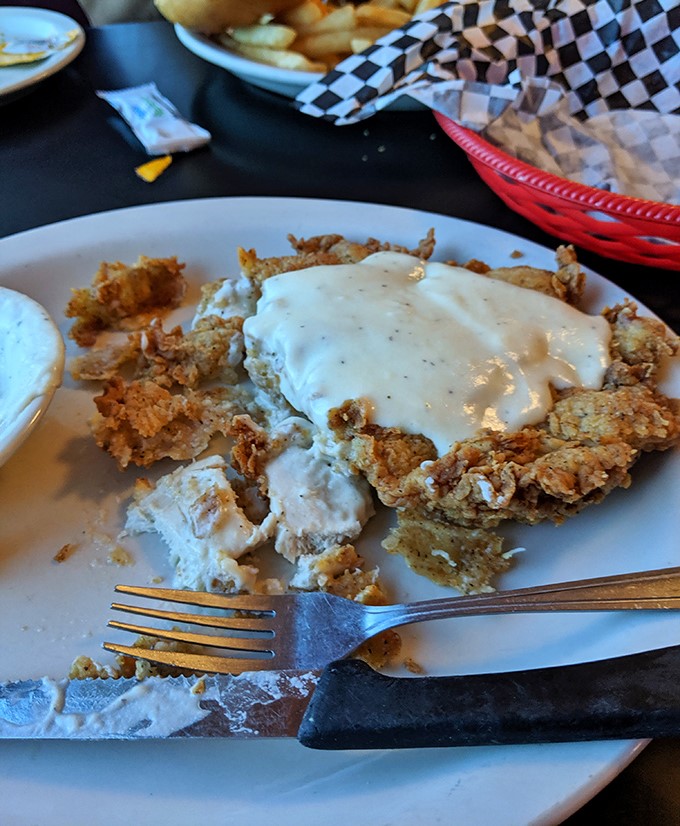 Behold the star of the show: chicken fried steak that's crispy, golden, and smothered in peppery cream gravy. Fork-tender perfection on a plate.