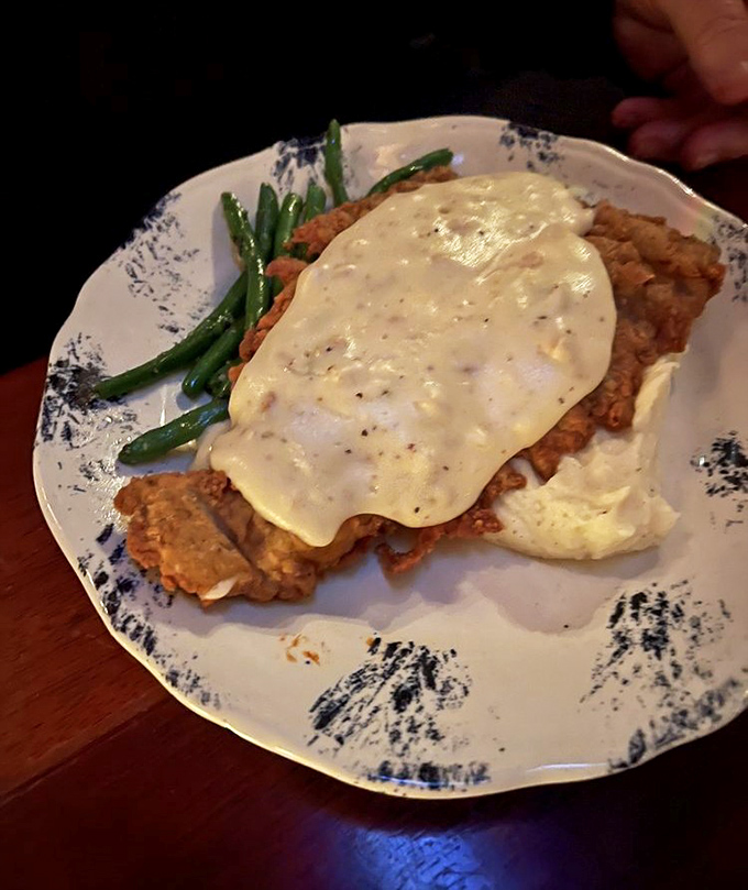 Behold the holy grail of Texas comfort food: chicken fried steak with pepper-flecked cream gravy that would make your grandmother both proud and jealous.
