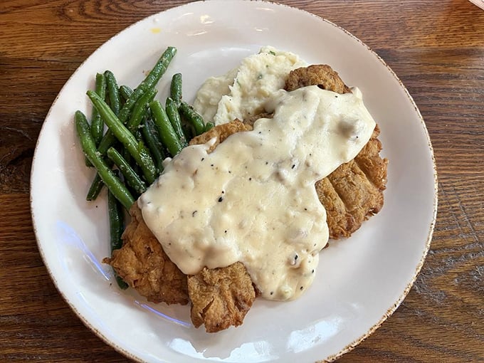 Behold the holy grail of Texas cuisine: chicken fried steak bathed in peppery cream gravy that would make your grandmother weep with joy.