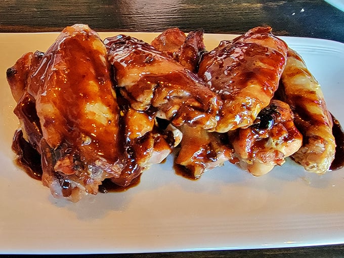 These aren't just wings; they're glossy, sticky masterpieces of sweet-spicy perfection that make you question why you ever ordered pizza in the first place.