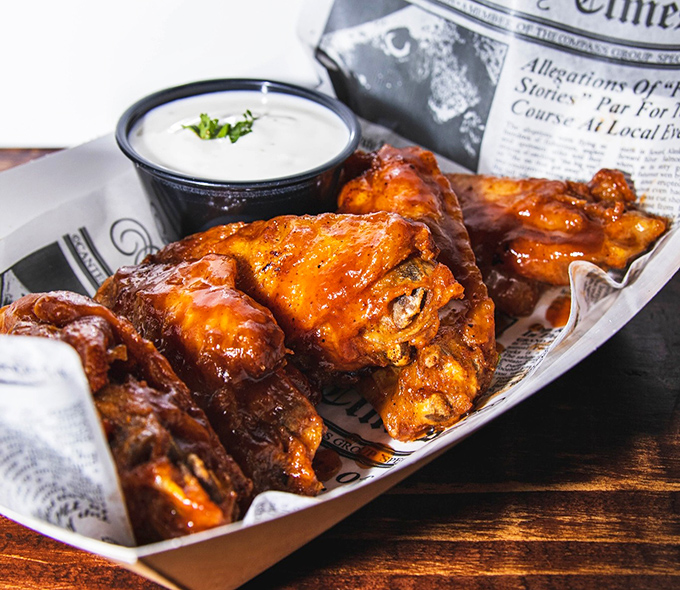 These aren't just wings; they're crispy-skinned vessels of joy. Glistening with sauce and served with cooling ranch, they're worth every napkin you'll need.