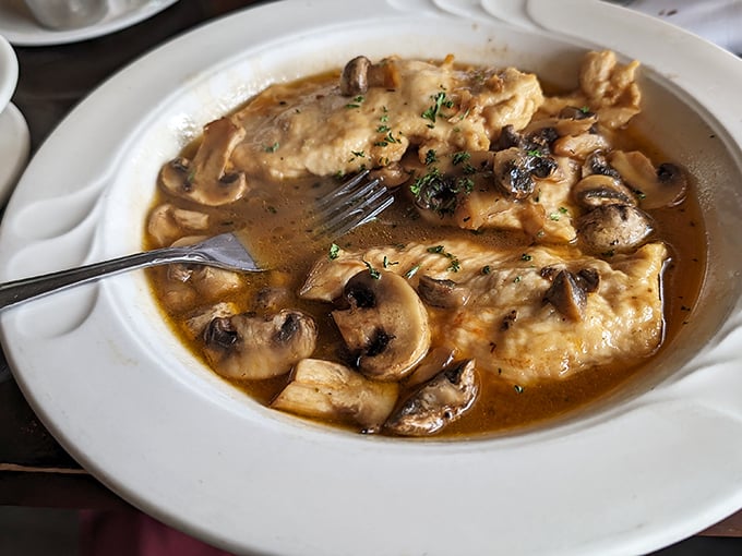 The Chicken Marsala arrives swimming in a wine sauce so rich it could buy a vacation home in Tuscany.