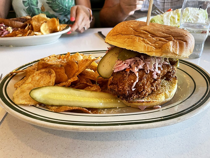 This isn't just a chicken sandwich; it's a masterclass in texture and flavor. The crispy coating, tangy slaw, and that pickle? Pure sandwich symphony.