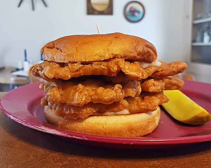 Architectural majesty on a plate. This towering chicken sandwich doesn't just feed you—it dares you to figure out how to get your mouth around it.