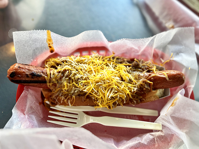 The star of the show in all its glory &ndash; a perfectly grilled dog smothered in homemade chili and blanketed with cheese.