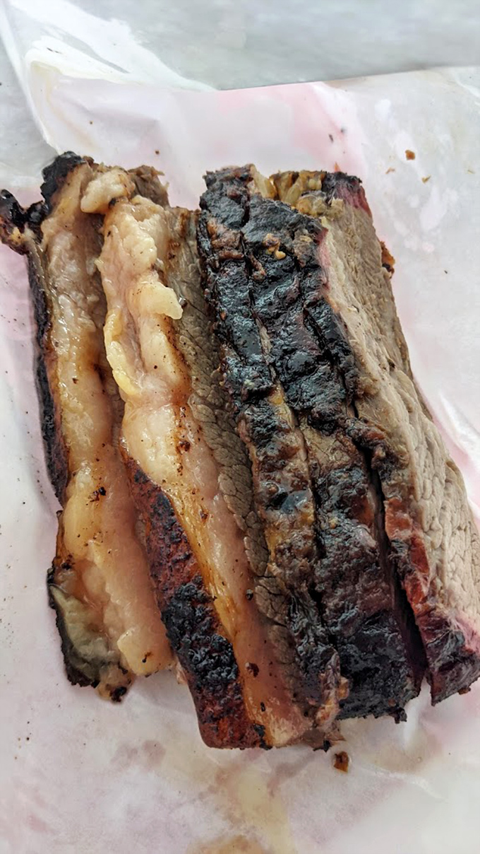Behold the holy trinity of barbecue perfection: bark, smoke ring, and tender meat. This brisket doesn't need Instagram filters&mdash;it's already wearing nature's most beautiful colors.