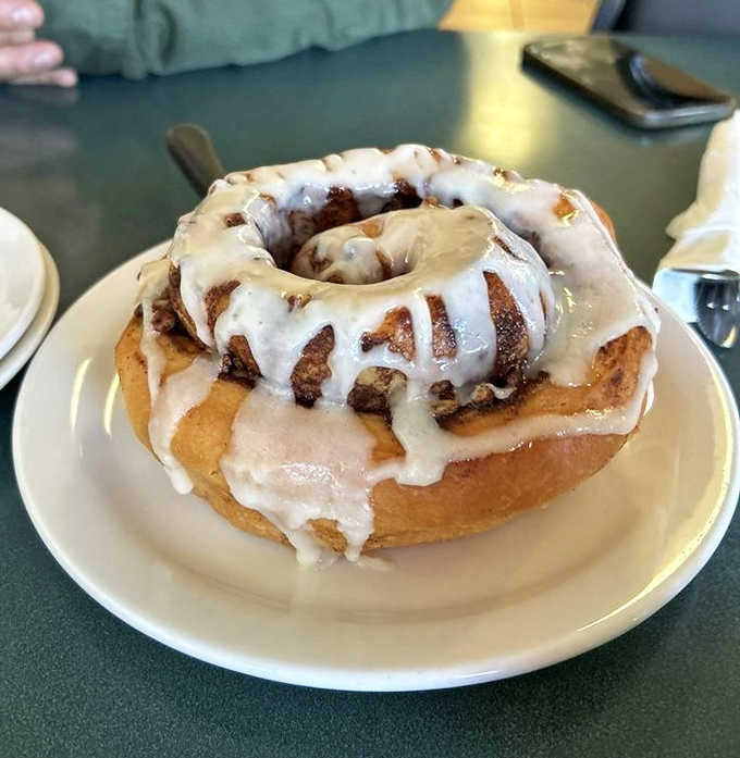 The legendary half-pounder in all its glory. This isn't just a cinnamon roll; it's an architectural achievement with frosting as the crowning glory.