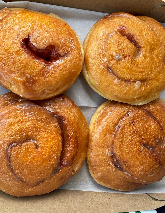 Cinnamon rolls that could make a carb-counter weep with joy. These golden spirals are what breakfast dreams are made of.