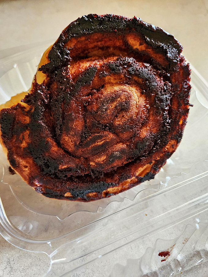 This cinnamon roll looks like it had a wild night out, but trust me, its caramelized edges are where flavor memories are born.