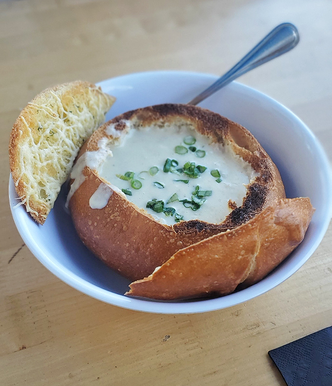 Bread bowl brilliance! This clam chowder isn't just served, it's presented&mdash;creamy, herb-flecked perfection nestled in a sourdough throne.
