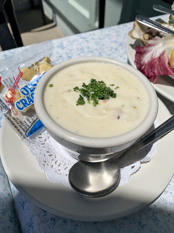 This isn't just clam chowder &ndash; it's a creamy ocean hug in a bowl, garnished with herbs and served with crackers for necessary dipping operations.