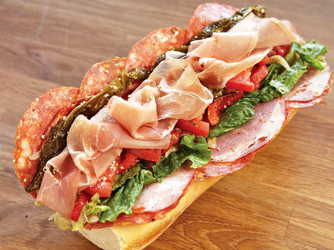Architectural perfection between bread &ndash; layers of Italian meats, cheese, and veggies stacked with the precision of a Renaissance masterpiece.