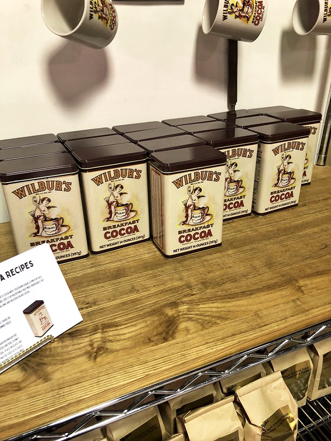 Vintage-style tins of Wilbur's Breakfast Cocoa line up like soldiers in a delicious army, ready to transform ordinary mornings into chocolate revelations.