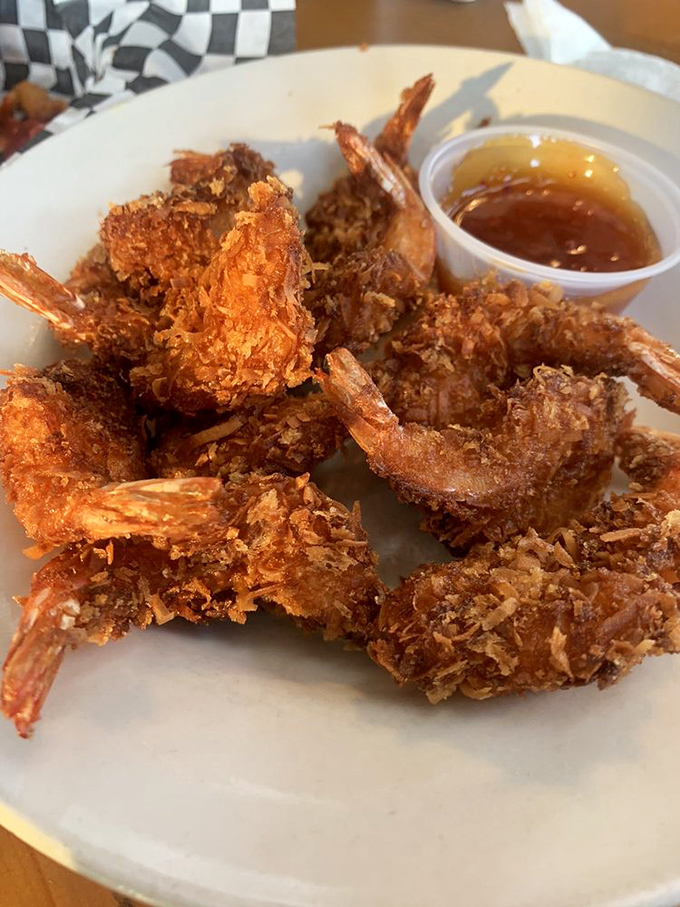 Golden-fried coconut shrimp that crunch like nature's perfect potato chip. The dipping sauce is just showing off at this point.