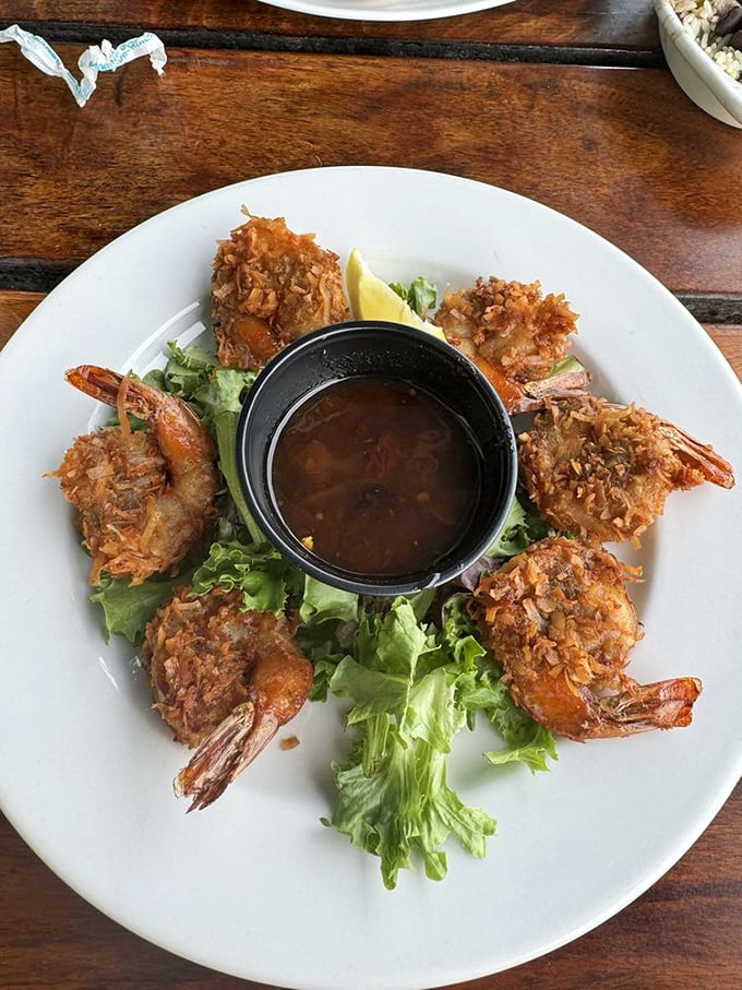 Golden-fried coconut shrimp arranged like a delicious clock around a dipping sauce&mdash;time stands still when food looks this good.