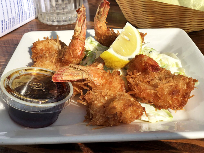 Golden-brown coconut shrimp that could make a mermaid swim to shore. Crispy, sweet, savory perfection served with a dipping sauce worth bottling.