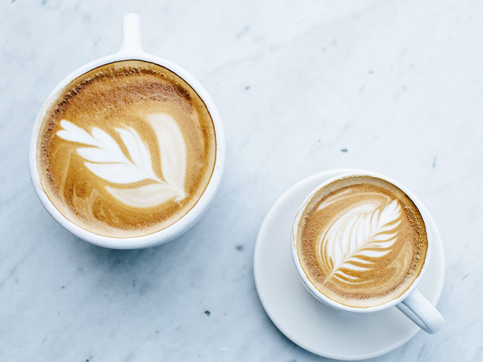 Two cups of liquid happiness, complete with latte art that's almost too pretty to drink.