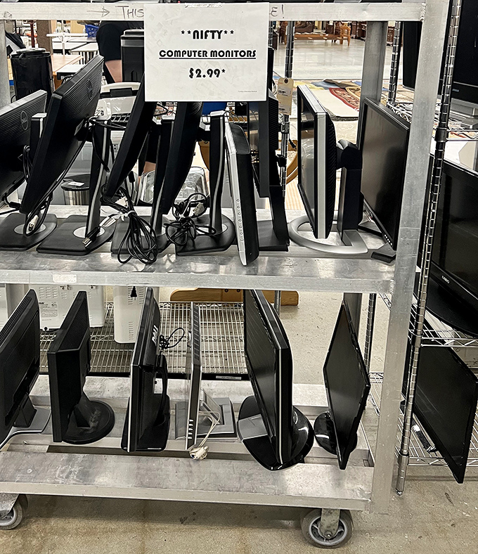 Computer monitors lined up like digital soldiers ready to upgrade someone's home office setup.