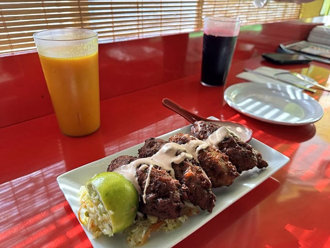 These conch fritters aren't just appetizers&mdash;they're little golden orbs of Caribbean joy, served with a sauce that could make cardboard taste magnificent.