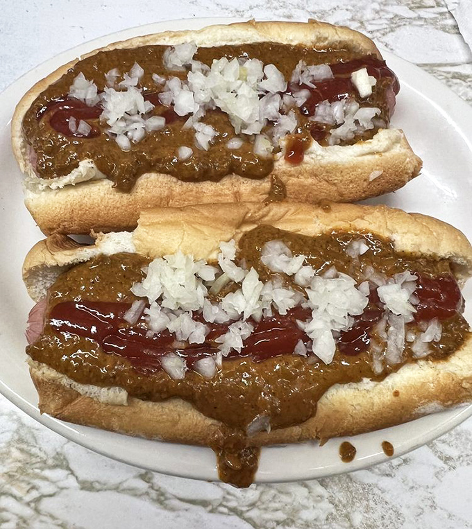 The main event, in all its glory. Two perfectly dressed coney dogs with that signature snap, smothered in beanless chili and topped with diced onions and mustard.